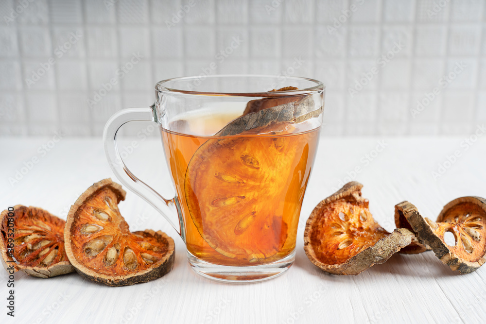 Traditional thai healing matoom tea made of dried bael fruit slices ...