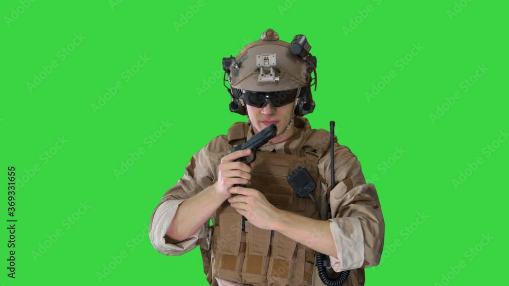 Soldier of army elite forces walking and shooting with pistol on a ...