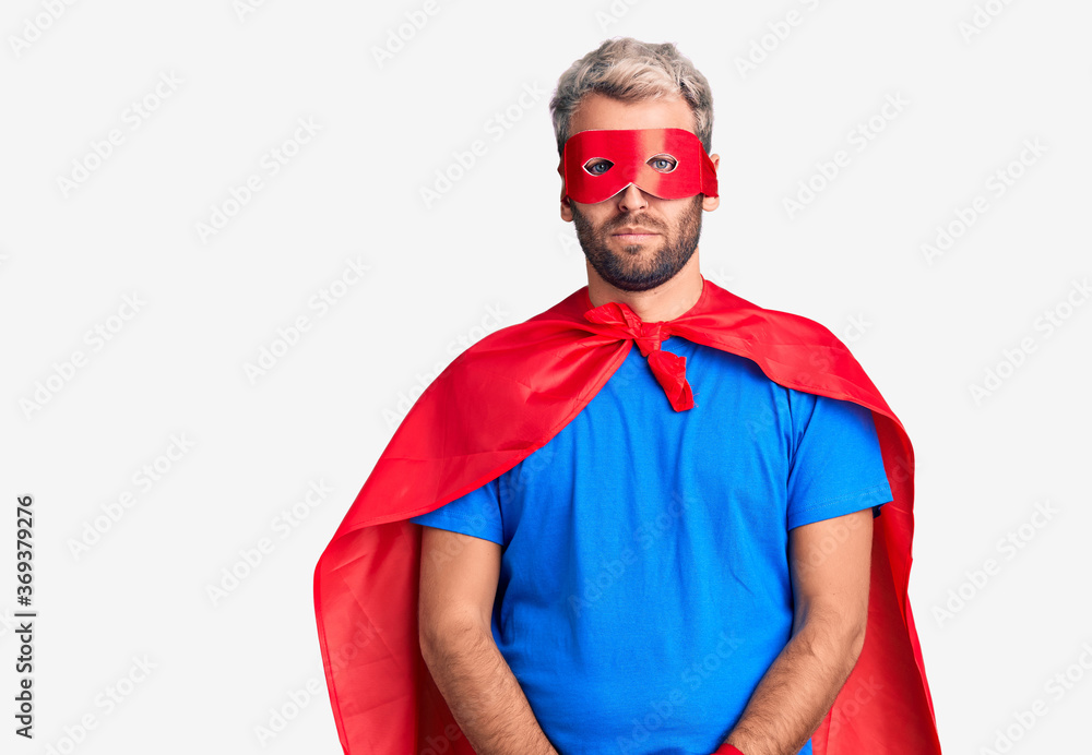 Young blond man wearing super hero custome depressed and worry for ...