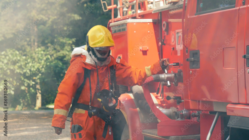 Firefighter fighting with flame using fire hose chemical water foam ...