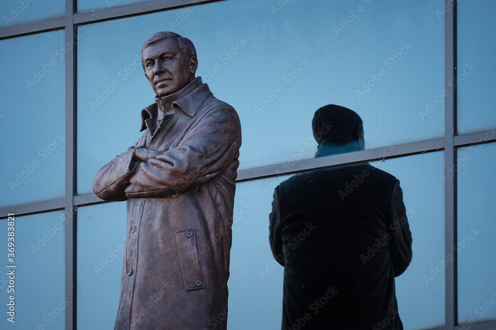 Manchester, UK - May 19 2018: Sir Alex Ferguson Bronze statue in front ...