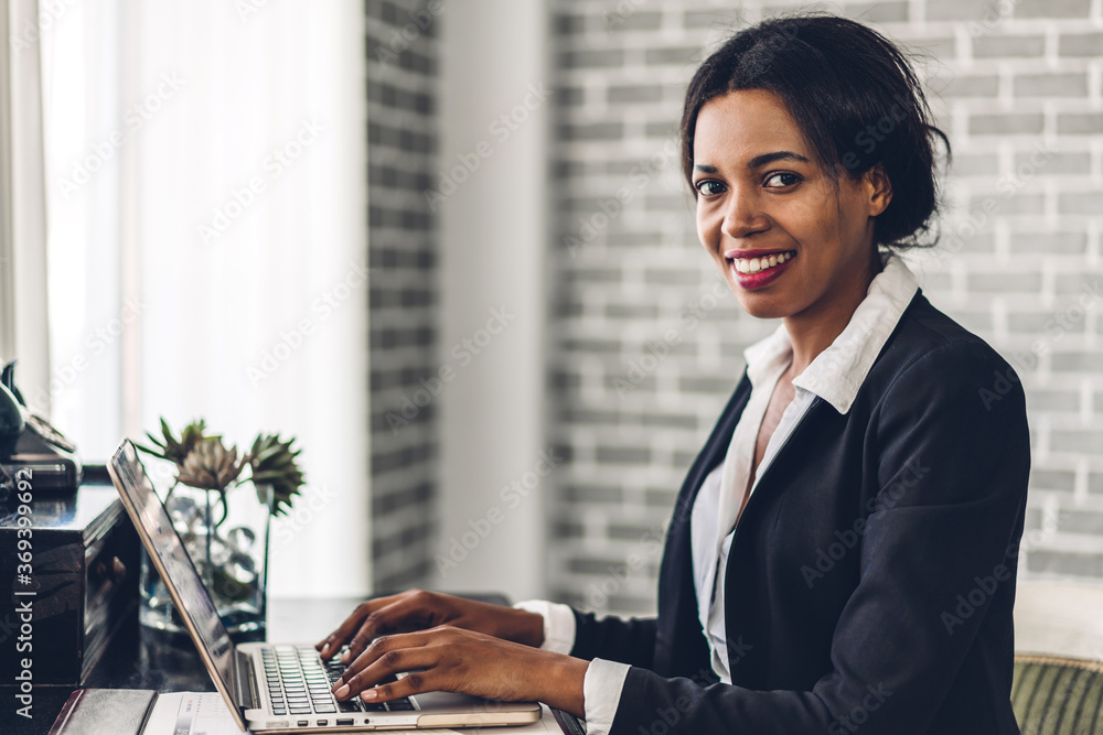 Portrait of smiling happy african american black woman relaxing using ...