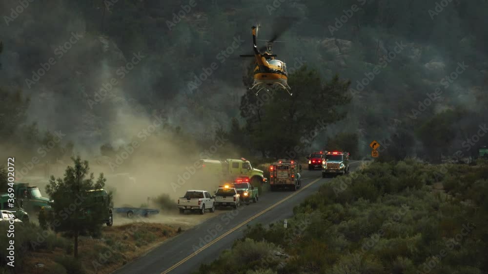 Fire fighting helicopter taking off from rural road near Kern River ...
