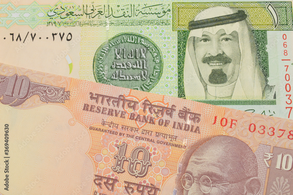 A macro image of a orange ten rupee bill from India paired up with a ...