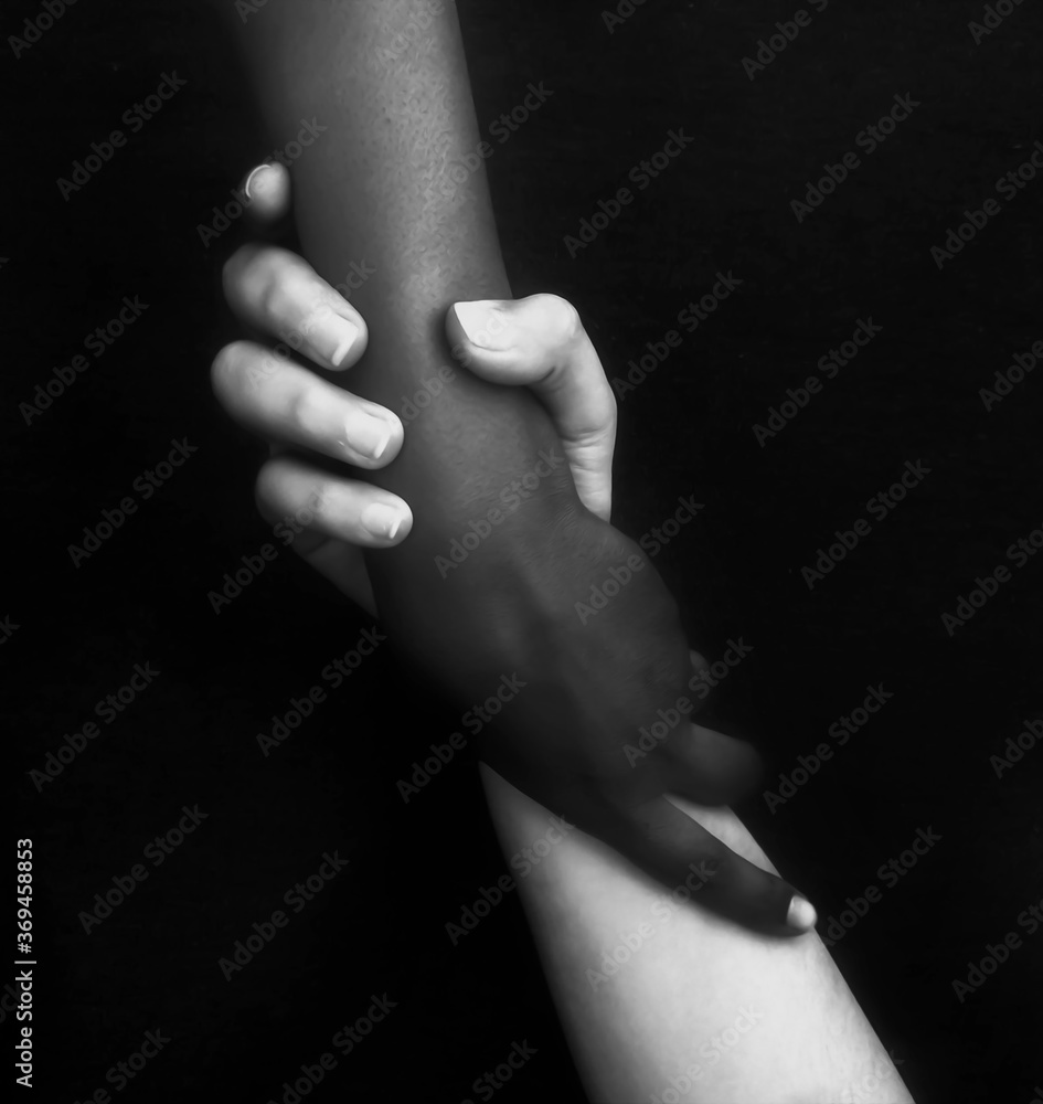 Monochromatic photo for two black & white hands with different ...