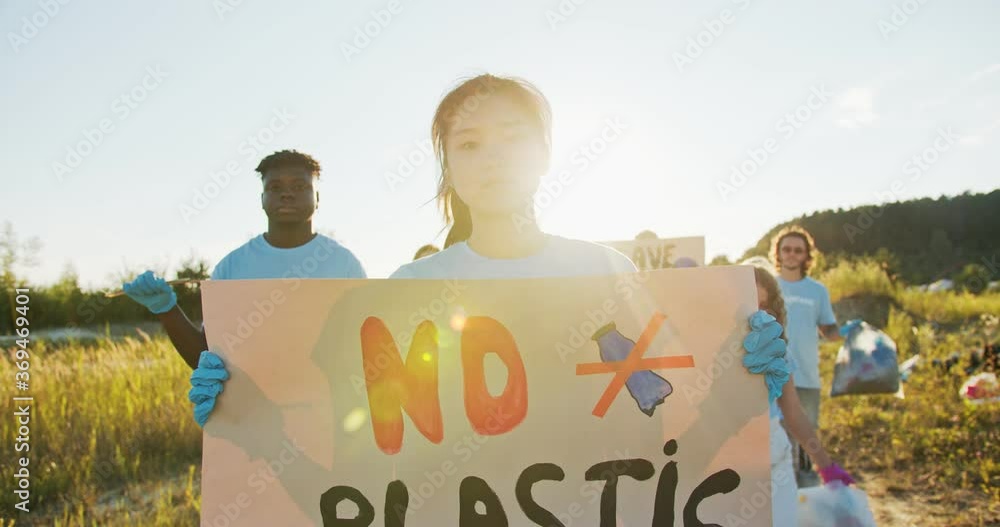 Pretty young Asian female volunteer protesting against plastic ...