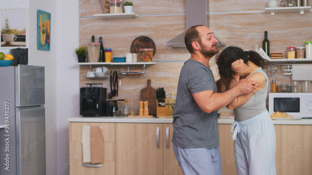 Violent husband shaking wife during disagreement at breakfast. Domestic ...