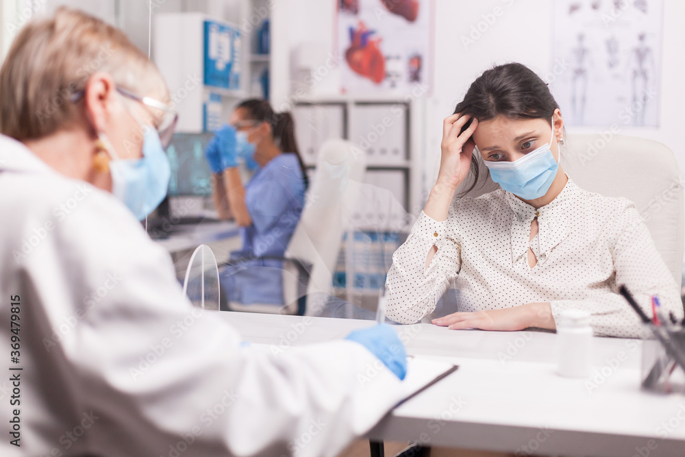 Young woman with protection mask against covid-19 crying during ...