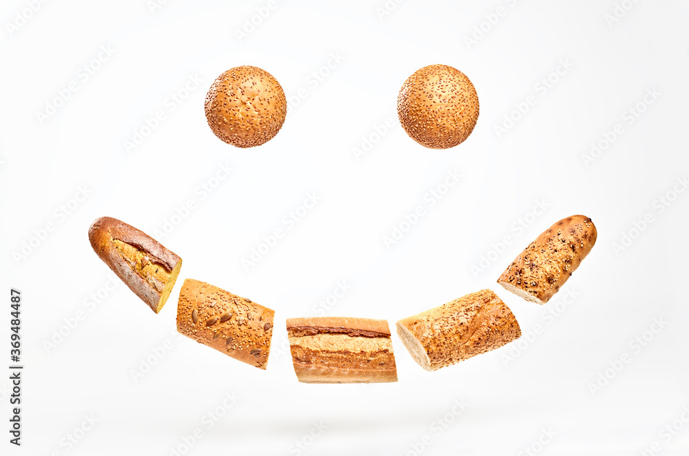 Baguette with sesame seed flying in air, smile shape. Fresh baked bread ...