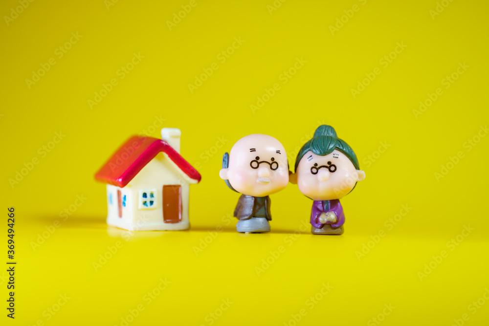 Miniature elderly people sitting with mini house using as job ...
