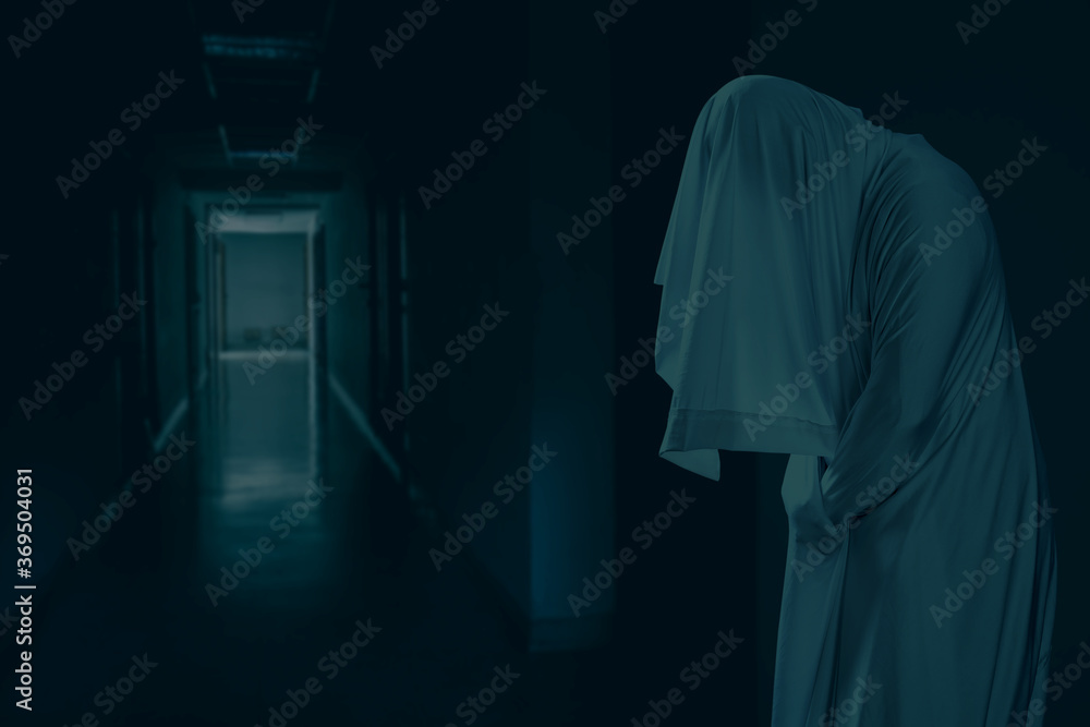 The man is in white clothes and shows a scary looking face at a creepy ...