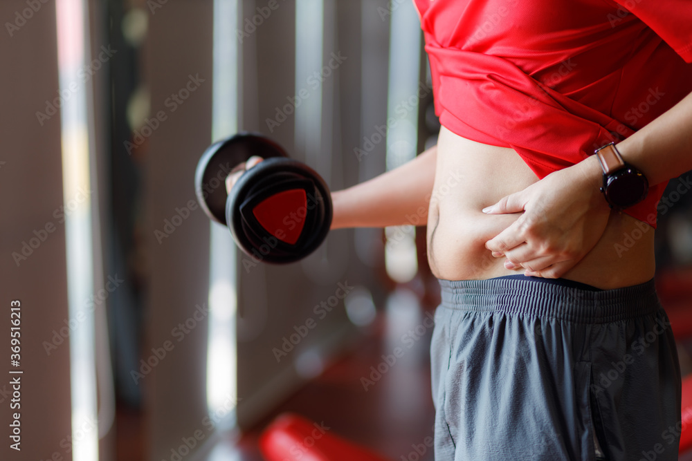 Fat man, Obese man hand holding excessive belly fat isolated on gym ...