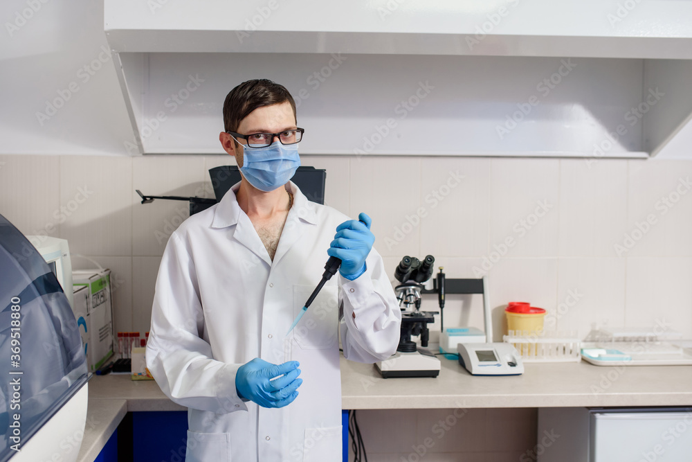 In the hospital laboratories working process, a young man doctor ...