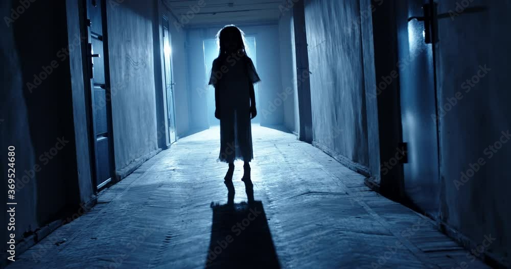 Little girl in white dress looking like a ghost carelessly running down ...