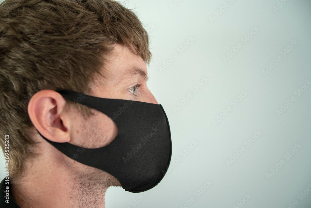 Man with black medical mask on face. Side profile portrait of man ...