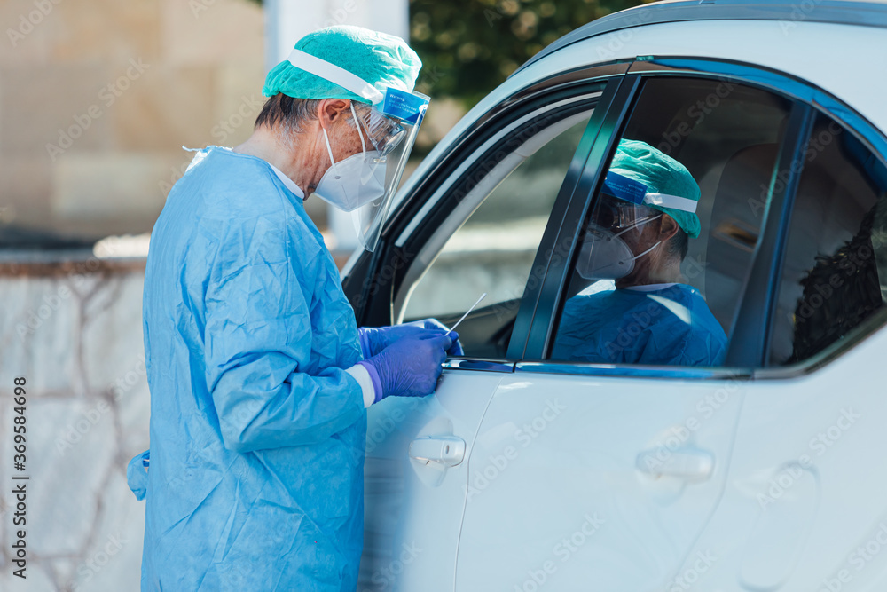 Medical personnel wearing a PPE, performing PCR on a patient inside the ...