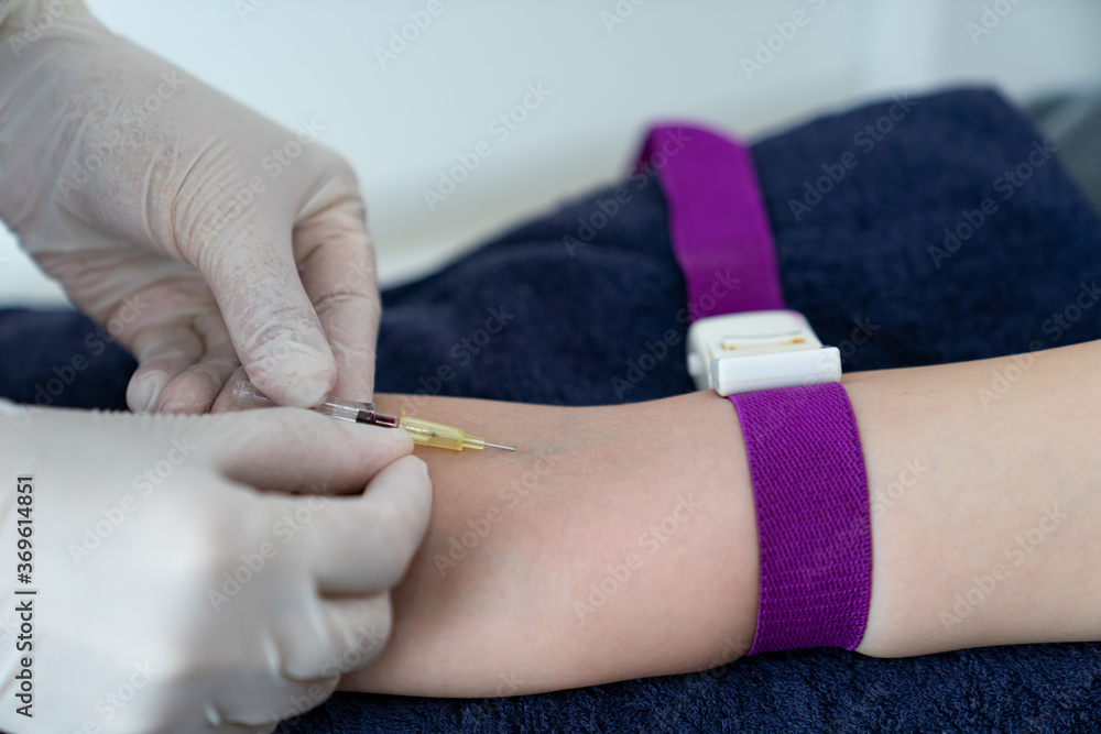 Doctor hand put intravenous(IV) injection on patient arm for drip ...