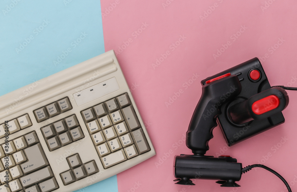 Old keyboard and joysticks on pink blue pastel background. Retro gaming ...