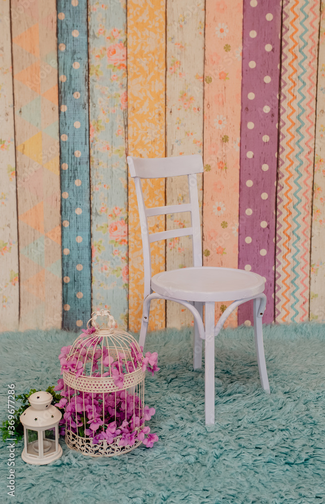 photo studio set up with a wooden chair flowers and a colourfur ...