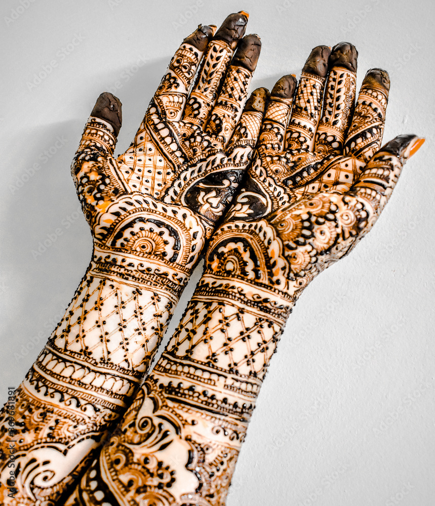 Beautiful artwork of Henna Mehndi on fair hands of young Indian girl ...