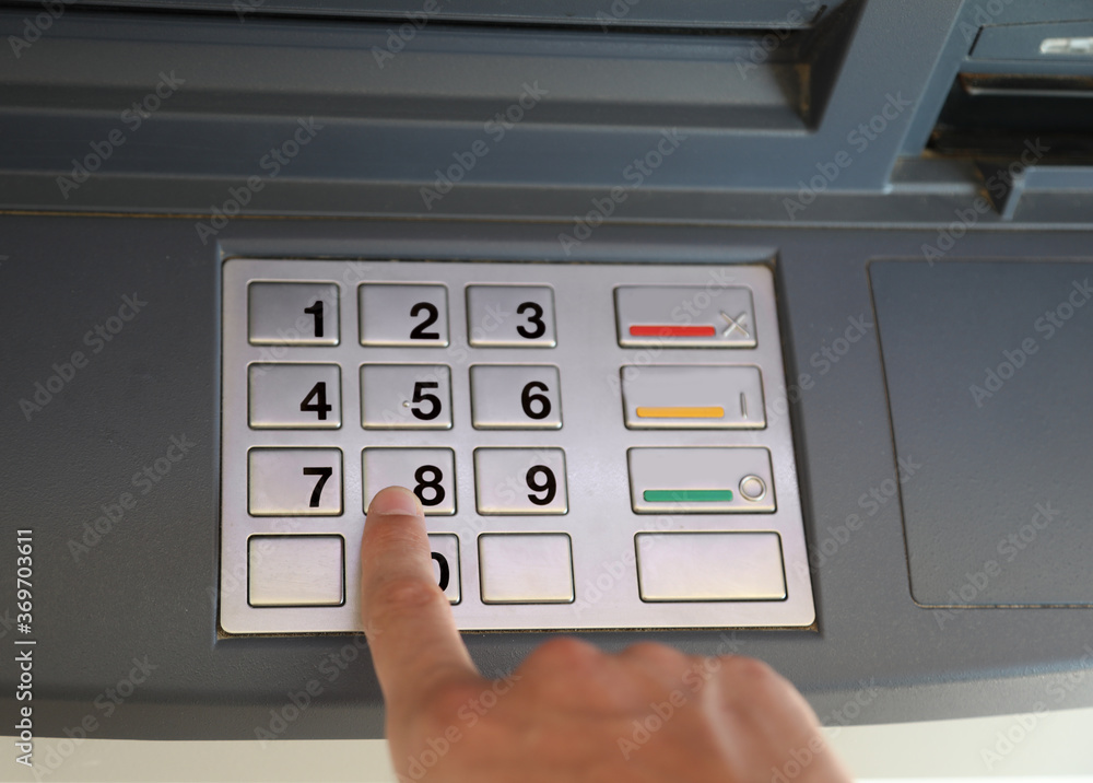 person typing the secret code into the ATM machine keyboard Stock Photo ...