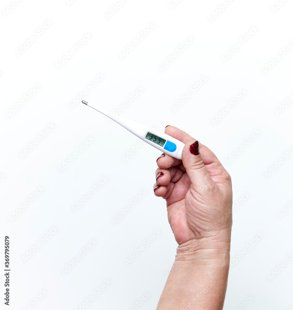 Old woman hands holding digital thermometer to measure body temperature ...