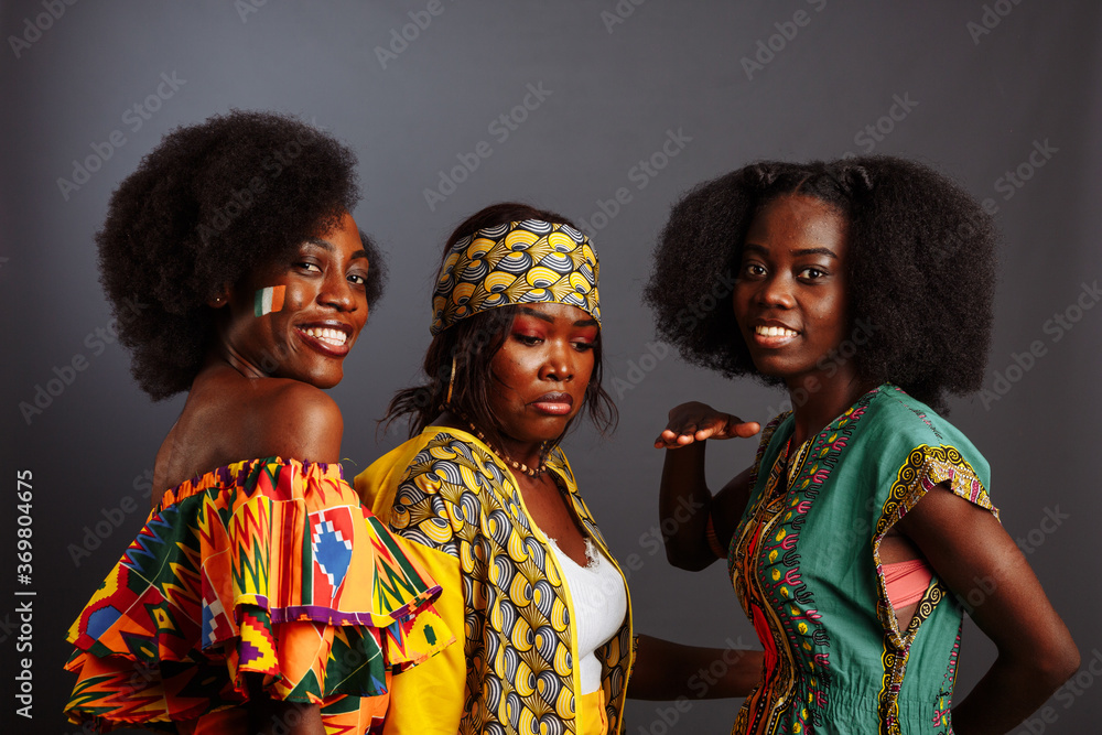 Three young beautiful African fashion models have fun and laughing in ...