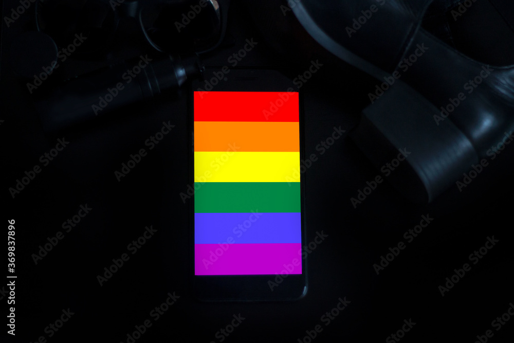 top view dark tone LGBT grooming concept with image of a LGBTQ+ flag ...