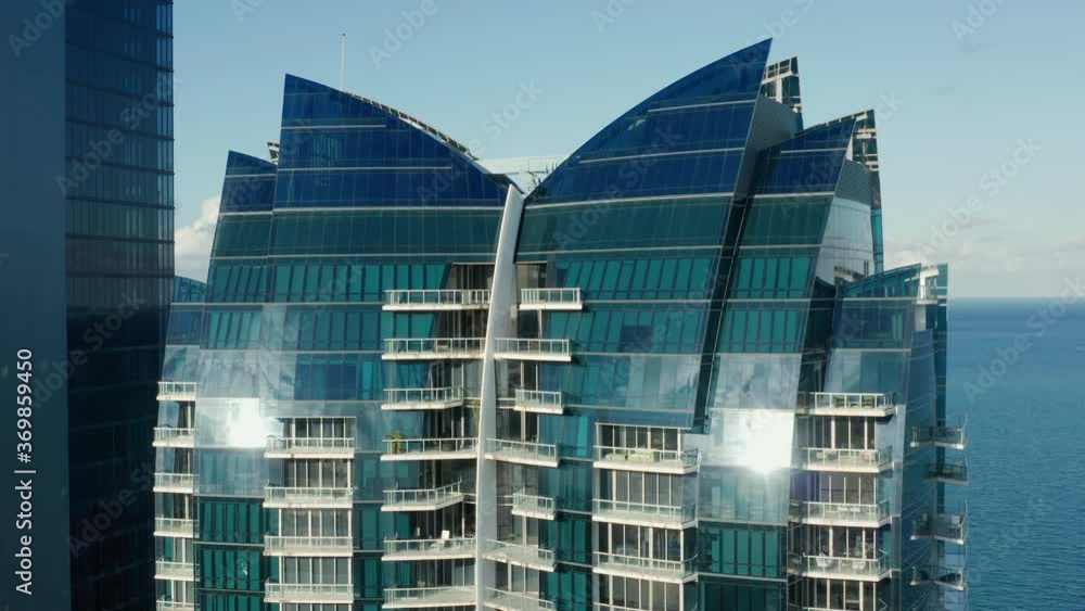 4K aerial Miami city South Beach. Modern wing-shaped design of glass ...