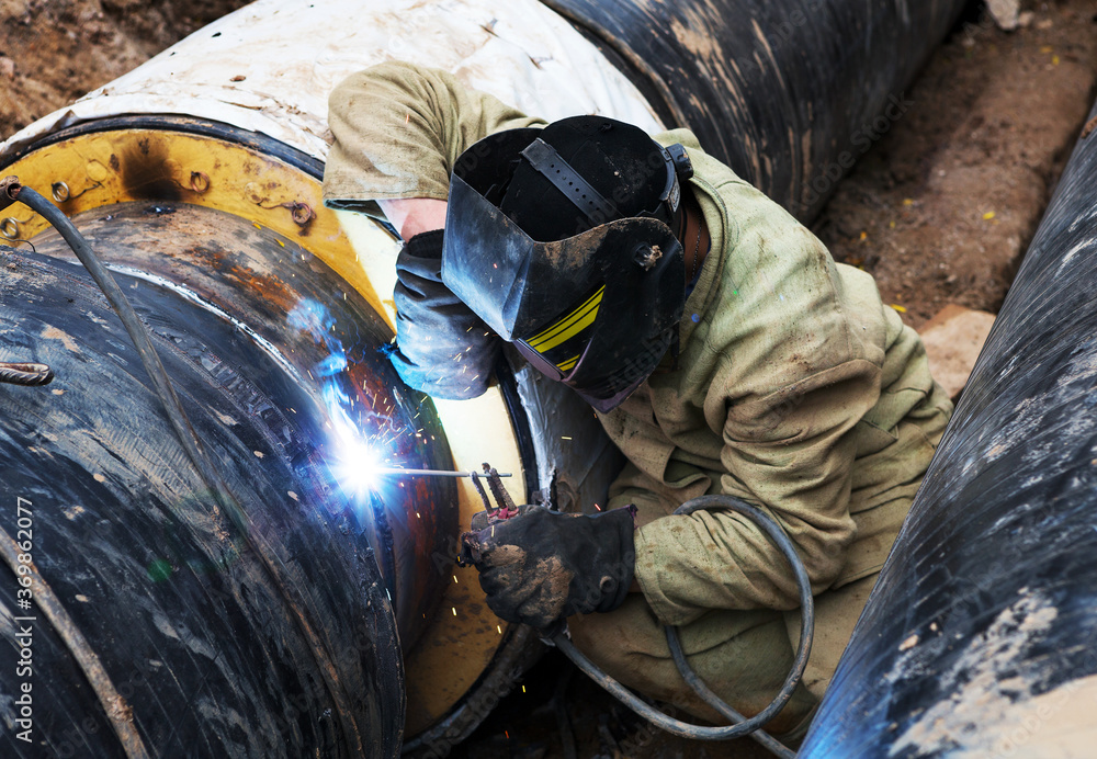 Repair of heating duct. The workers, welders made by electric welding ...