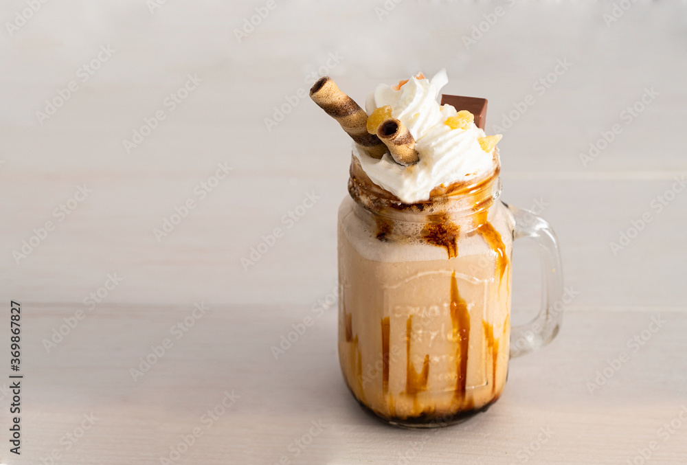 Milkshake mason jar with whipped cream and caramel decorated with ...