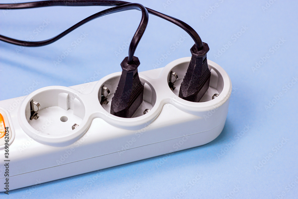 Triple socket white European power adapter with different wires at home ...