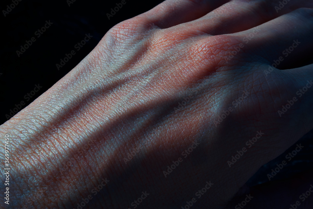 hand with blue blood veins in the dark closeup Stock Photo | Adobe Stock