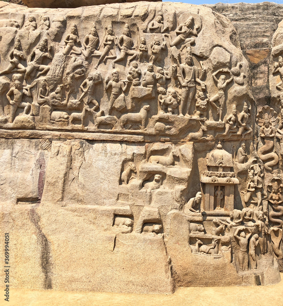 Ancient bas relief sculptures on the wall of the rock cut cave temples in Mahabalipuram, Tamil ...