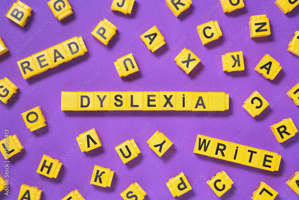 Foto de Dyslexia, read write words yellow on pink purple with scattered ...