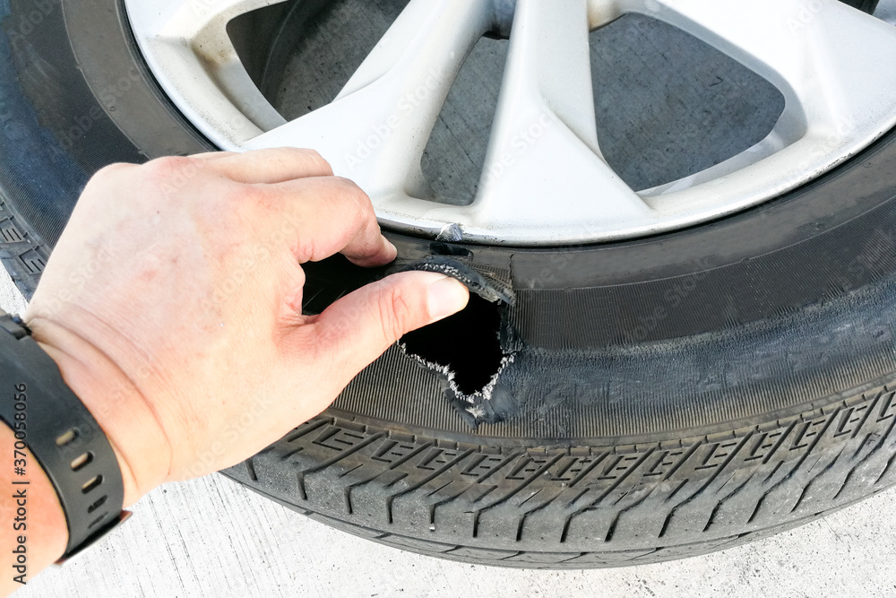 Hand showing flat ruptured damaged tire wheel with rim Stock Photo ...