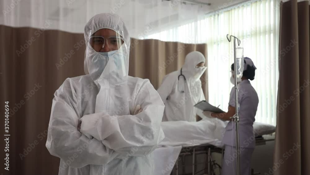 Portraits of doctors and nurses wearing COVID protective clothing in a ...