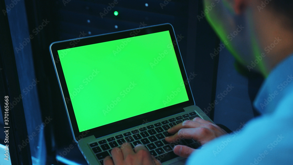 Professional IT worker using a mock-up laptop computer, typing on ...