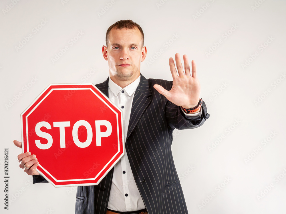 A man with a STOP sign and an outstretched hand. The man gestures and ...