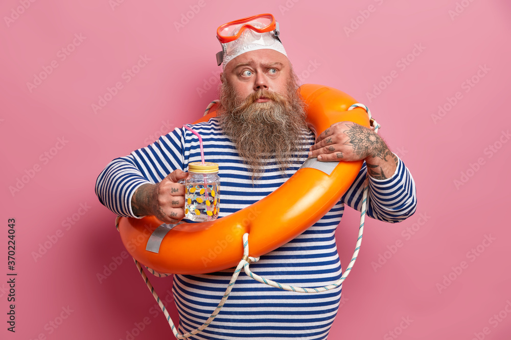 Fotografia do Stock: Serious fat man frowns eyesbrows, holds glass ...