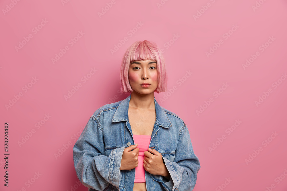 Indoor shot of serious pink haired female model dressed in top and ...