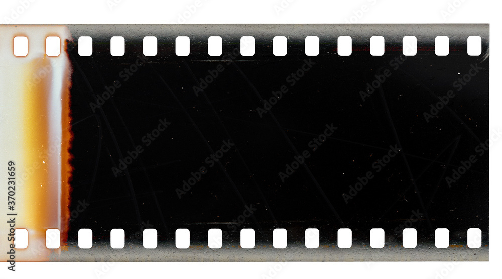 Burnt start of 35mm negative filmstrip, first dark frame on white ...