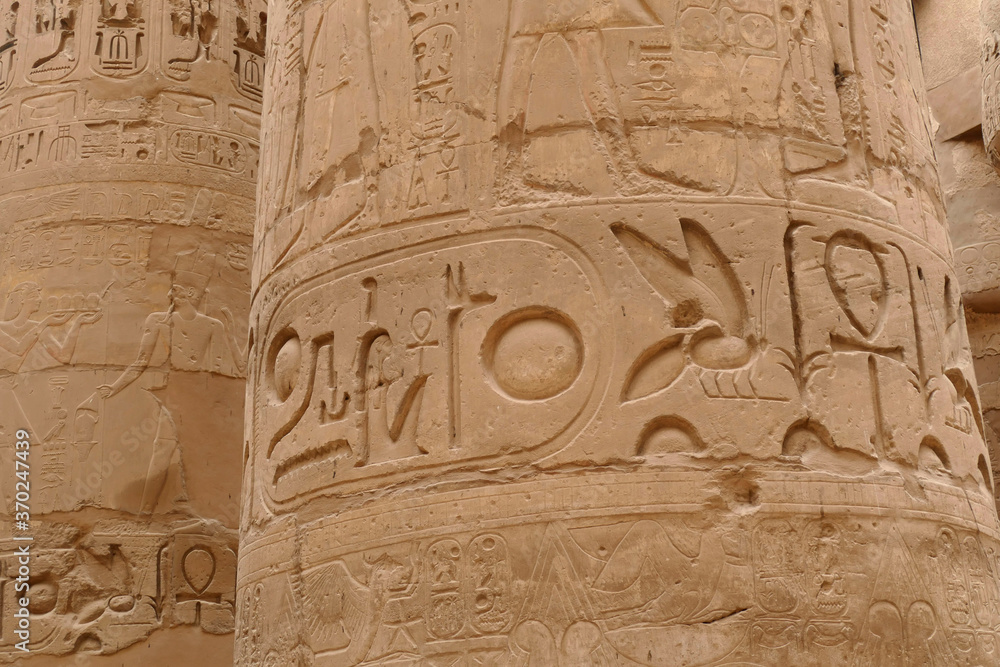 Hieroglyphics on the massive columns of the hypostyle Stock Photo ...