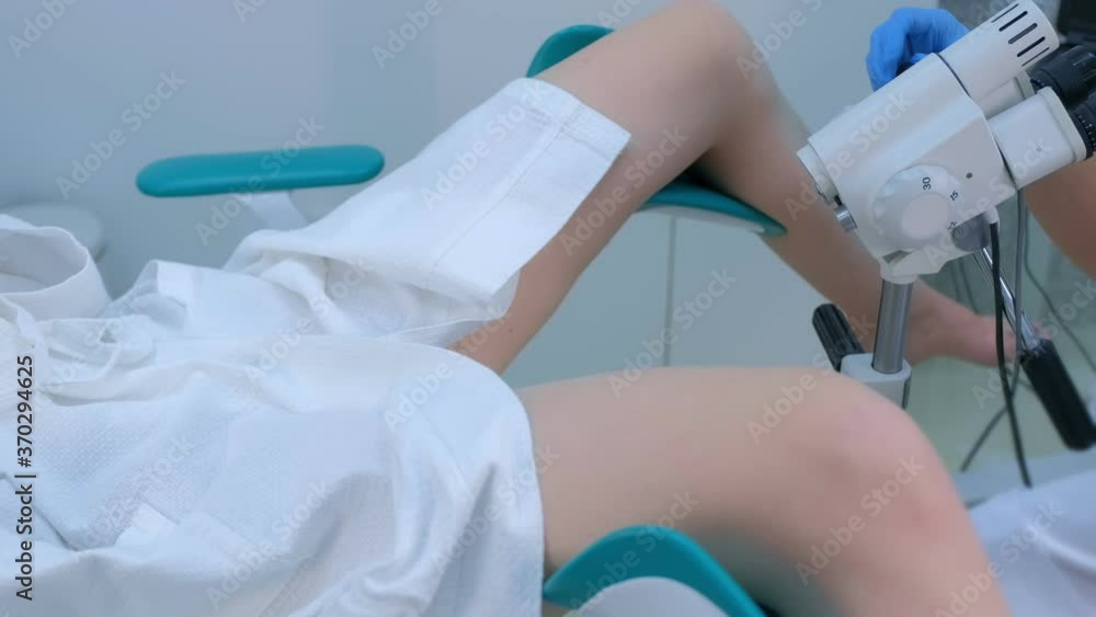 Patient And Doctor In Gynecological Office On Colposcopy Procedure Side View Legs Closeup