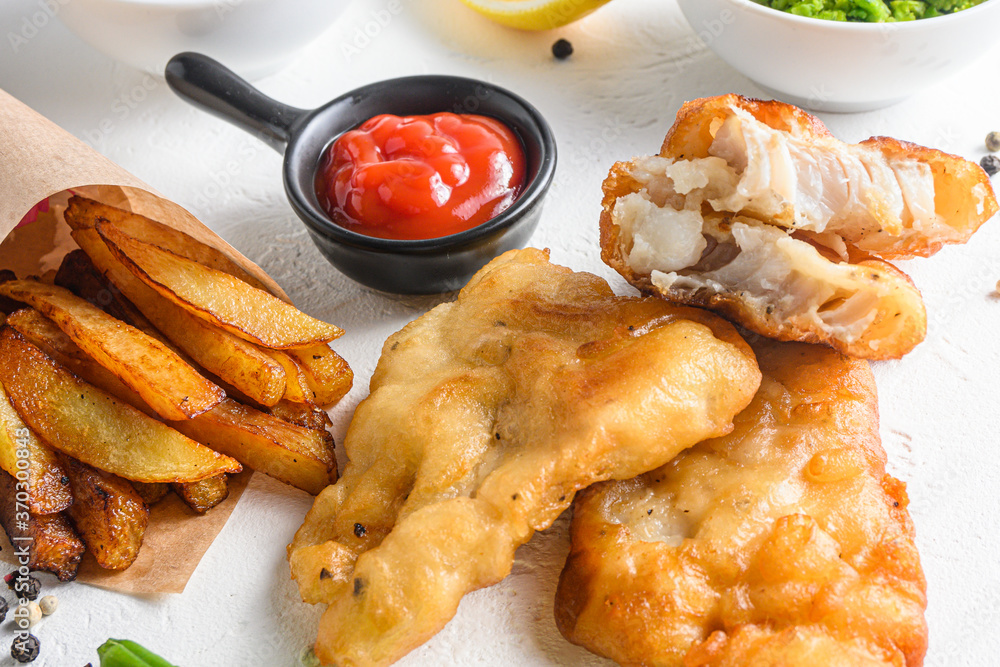Fishand chips battered crispy cod fillet detail with dip and lemon in a ...
