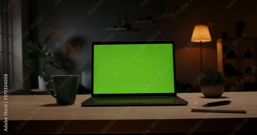 Chroma key green screen template - a laptop computer on a desk in cozy ...