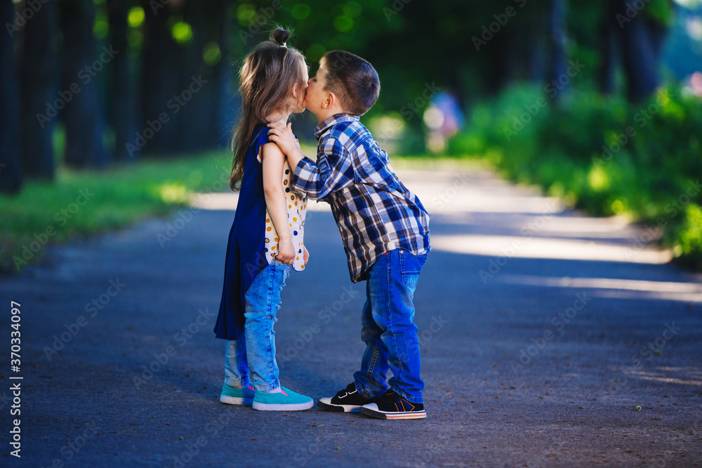 Children's love, a little boy and a girl, having fun, laugh and smile ...