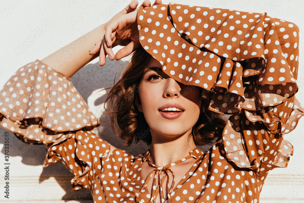 Portrait of inspired female model in beautiful brown dress. Photo of ...