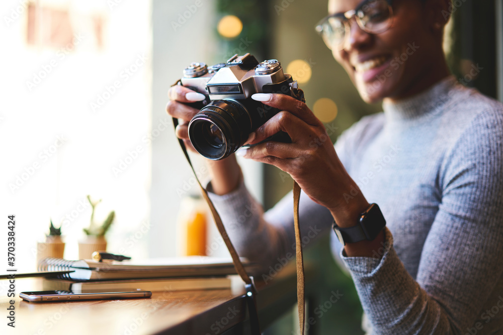 Portrait of cheerful talented female photo reporter feeling excited ...