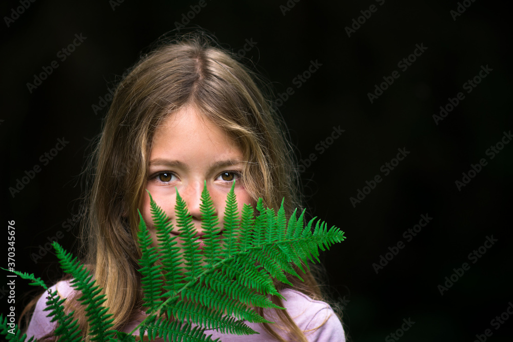 Beautiful young girl with perfect skin posing in front of green fern in ...